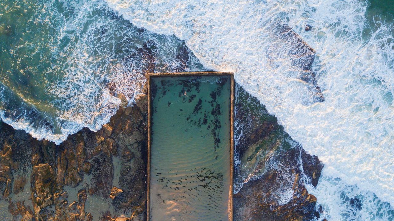 Aerial view of Cronulla rock pool with incoming waves, New South Wales ...