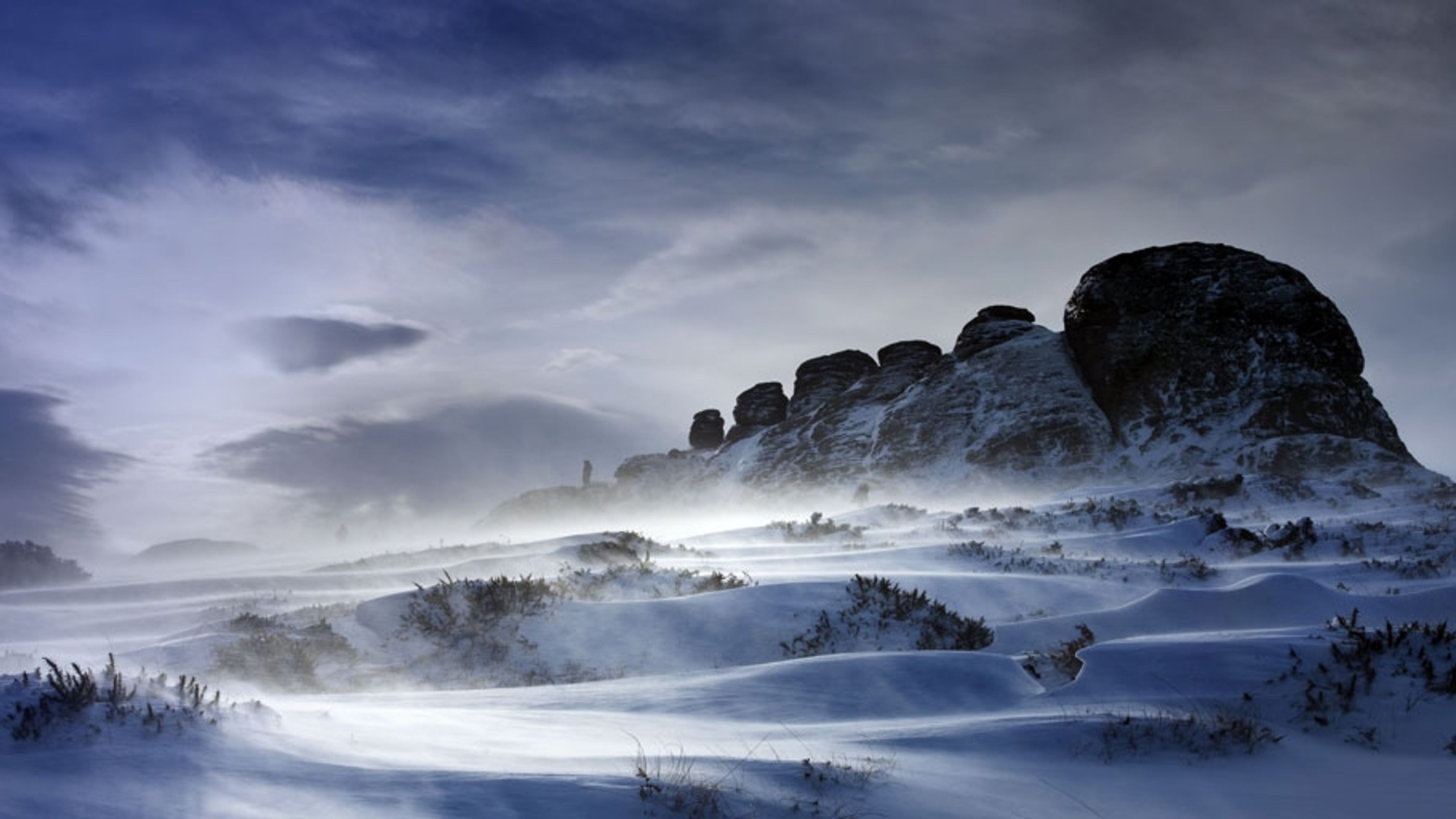 Haytor Rocks after a heavy snow fall, spin drift carried across the ...