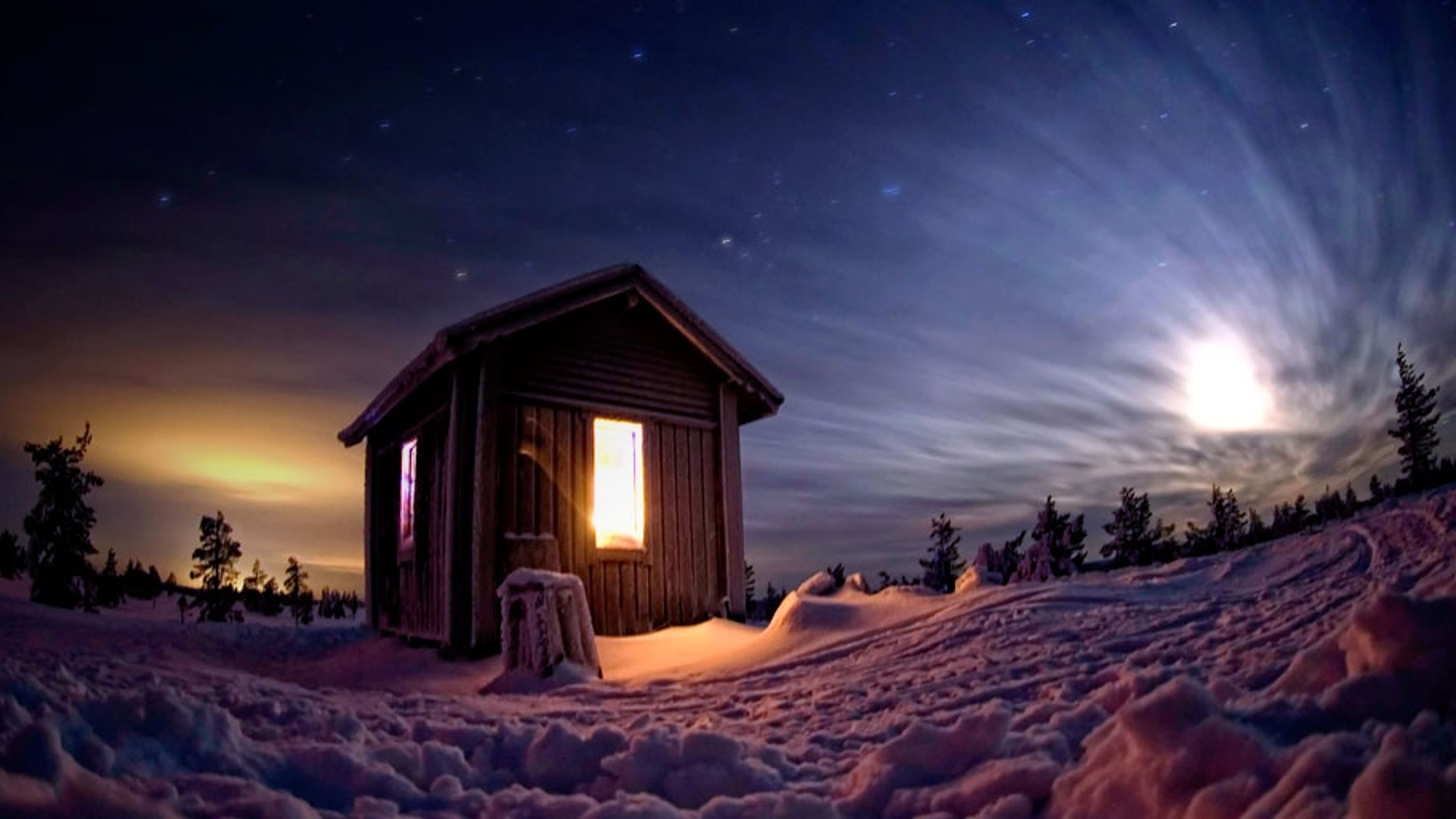 Mountain hut in wilderness with stars and moon at night during winter ...