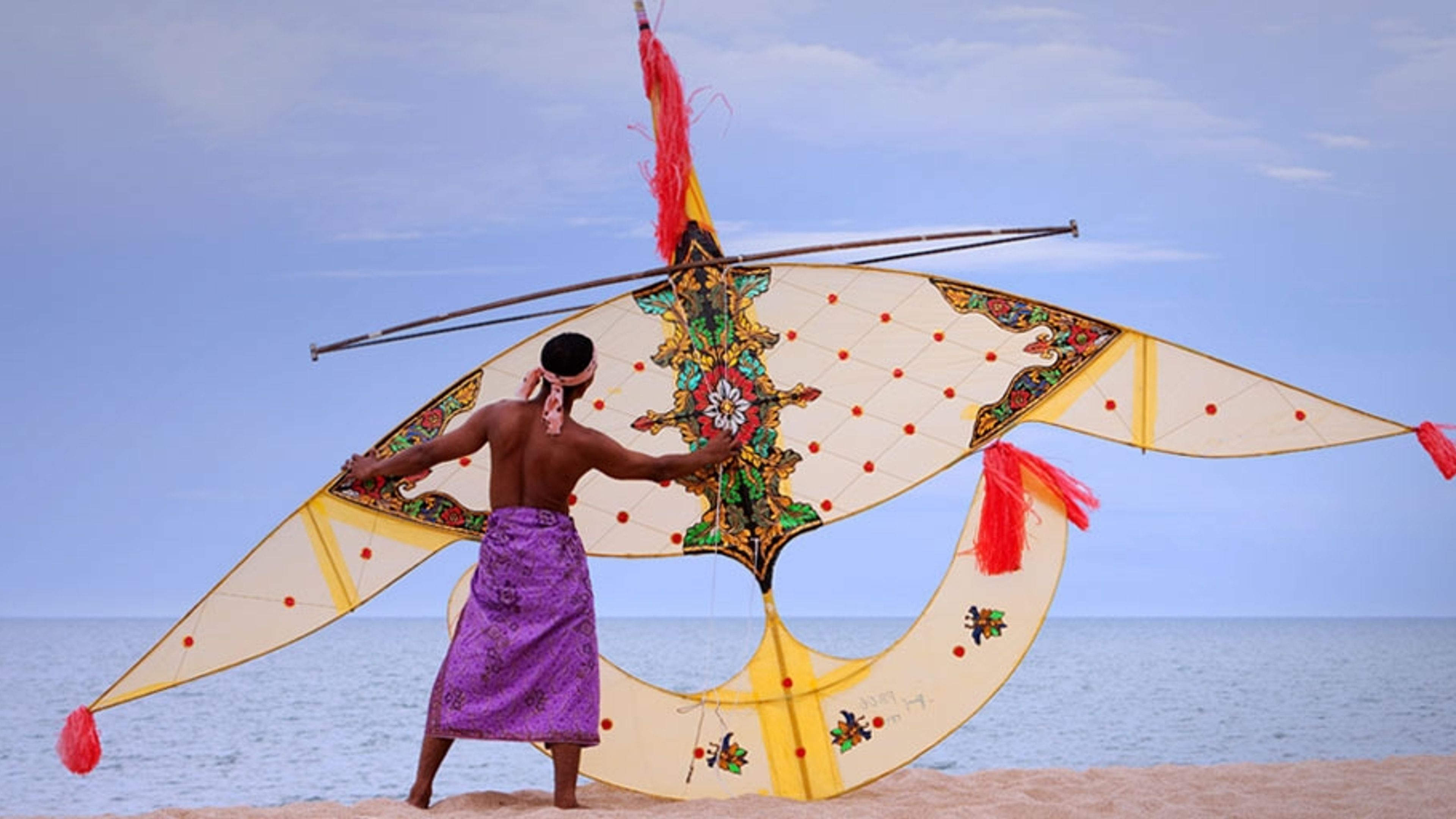 A Malaysian man holds a traditional handmade kite - Bing Gallery