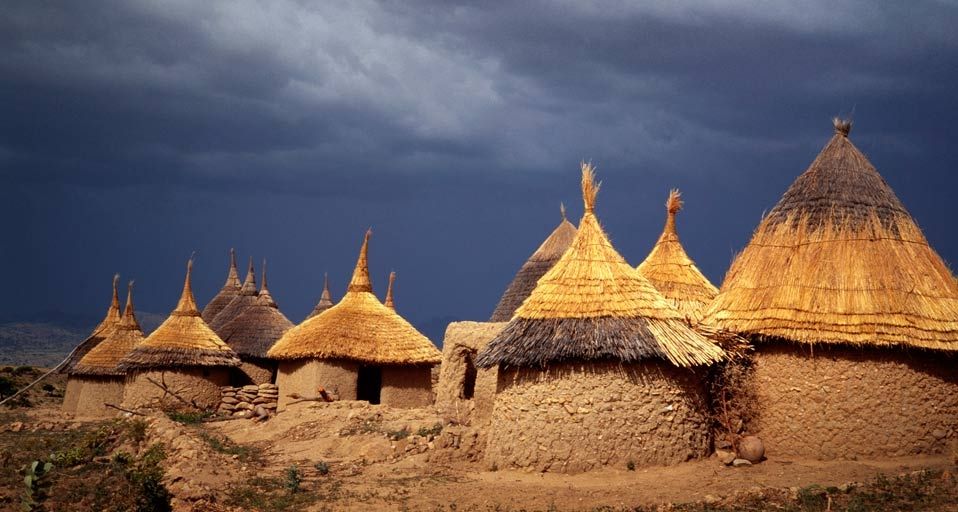 Round adobe huts with straw roofs in the Mandara Mountains, Cameroon ...