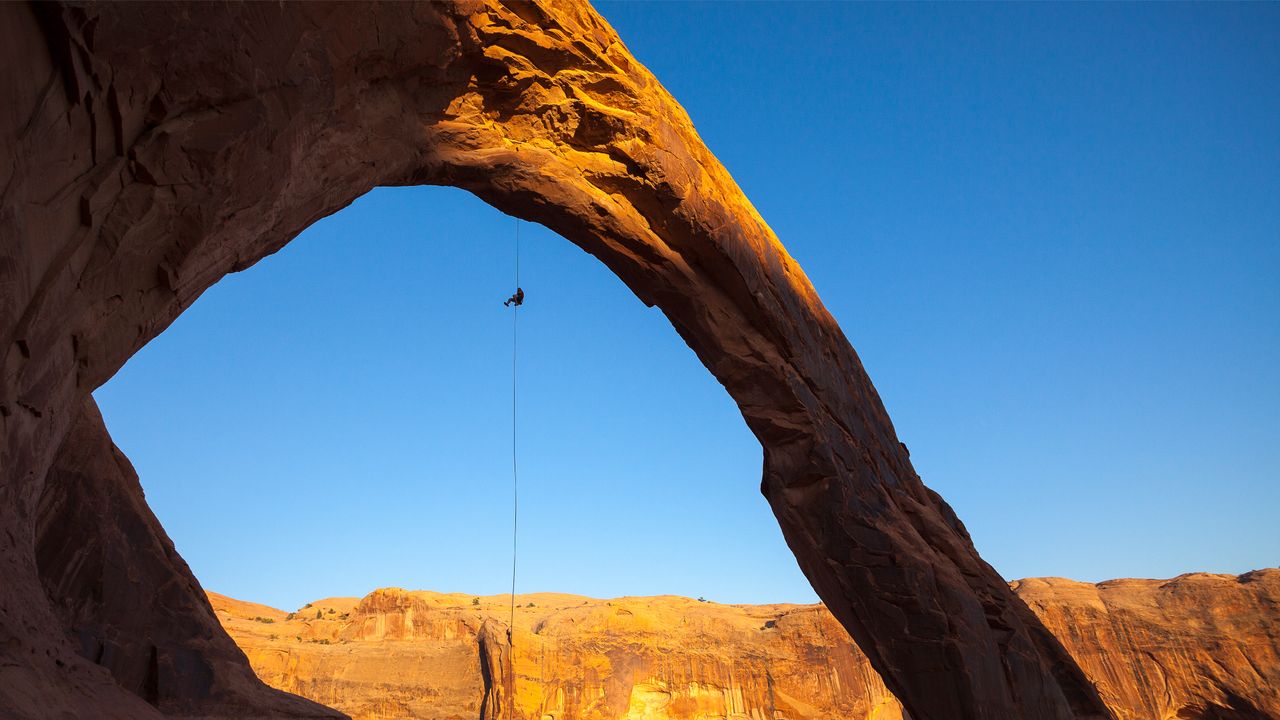 A man rappels off Corona Arch near Moab, Utah, United States - Bing ...
