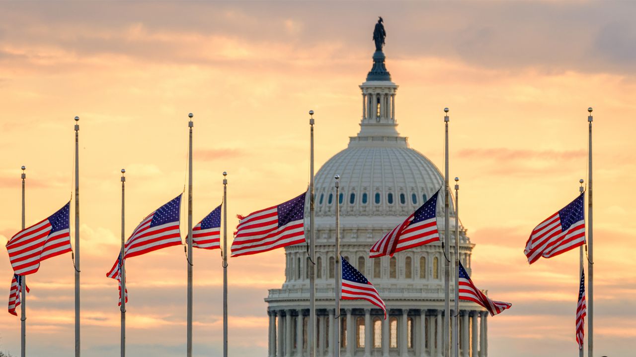 The US Capitol dome with flags flying at half-staff in honor of former President Jimmy Carter ...