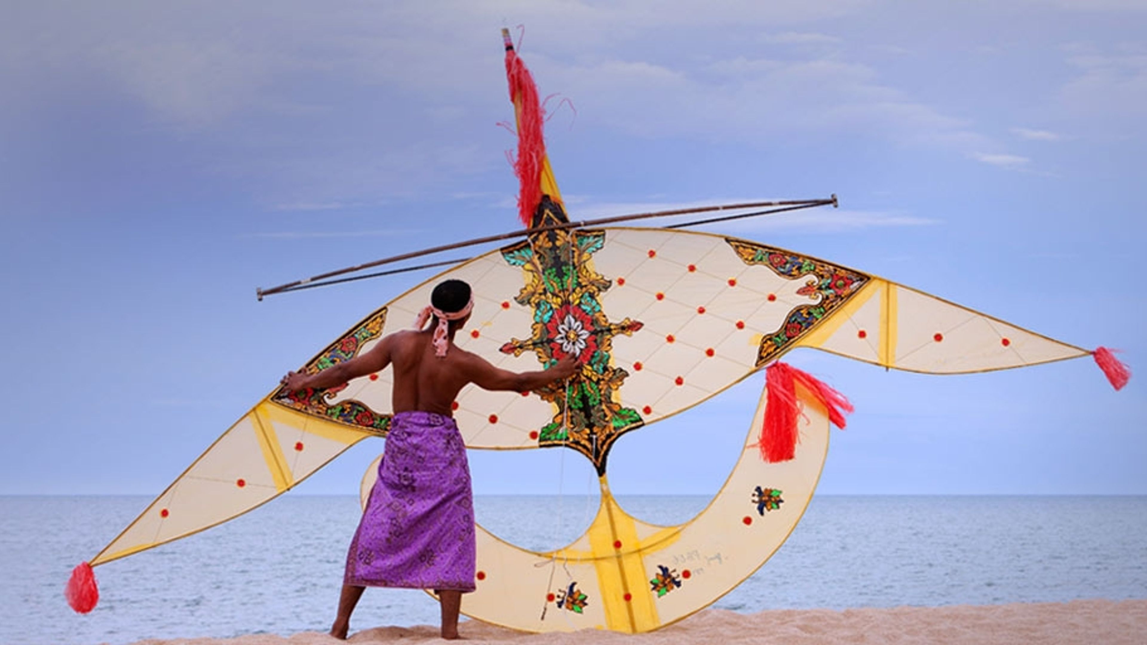 A Malaysian man holds a traditional handmade kite - Bing Gallery
