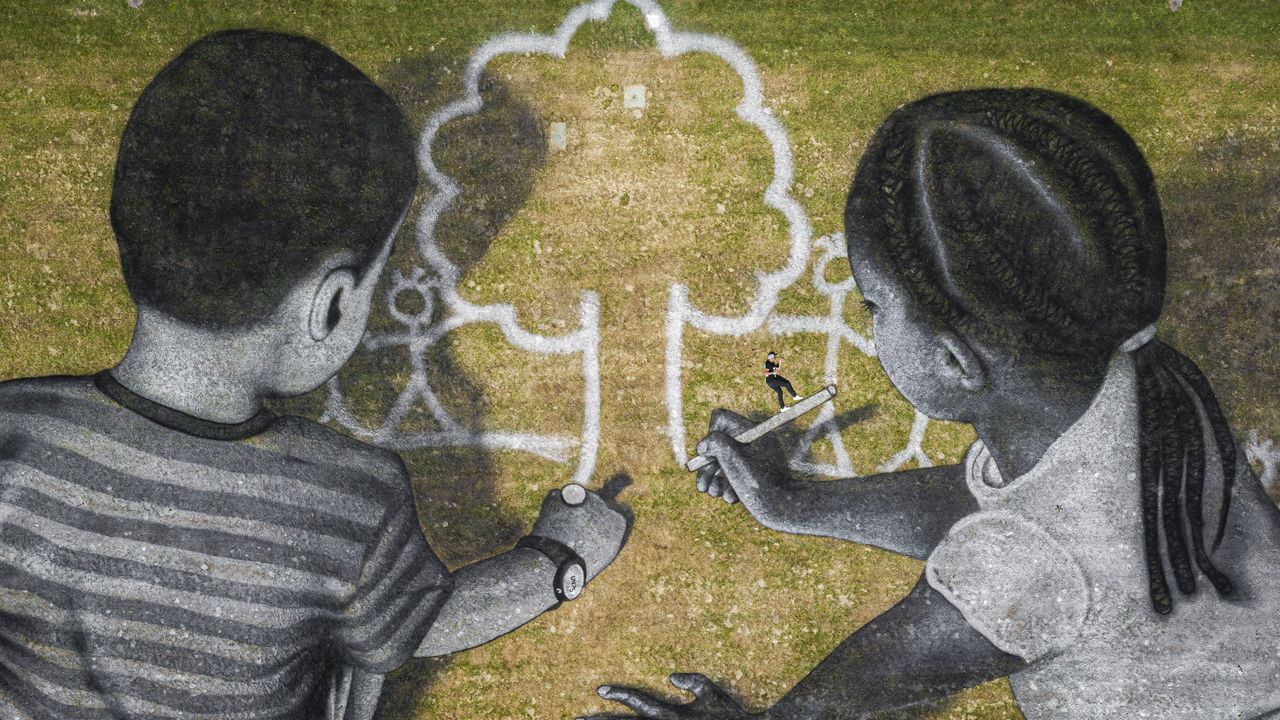 Artist Saype poses with his land art painting at UN Headquarters ...